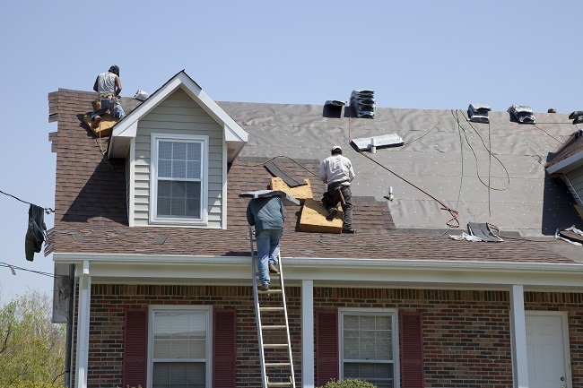 Roofers working - Vera Roofing & Construction